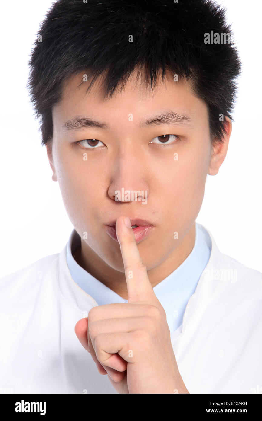 Asian man making a shushing gesture Stock Photo - Alamy