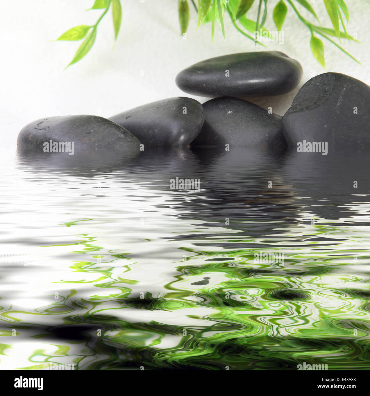 Black basalt spa stones in water Stock Photo - Alamy