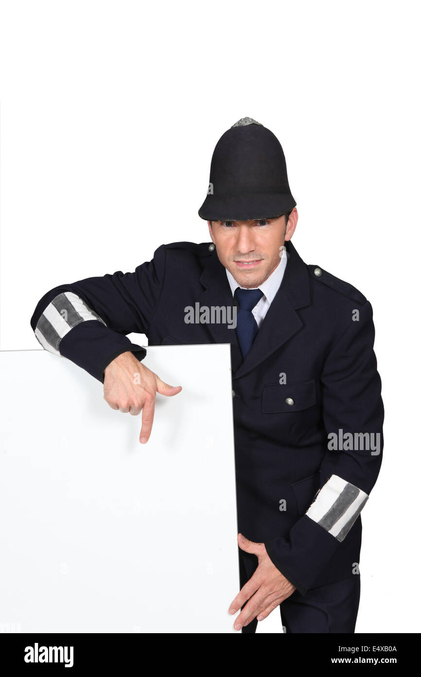 Policeman pointing to advertising board Stock Photo - Alamy