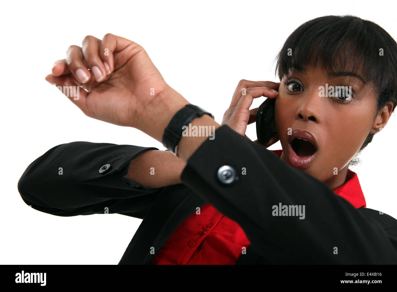 A woman frantically looking at the time Stock Photo - Alamy