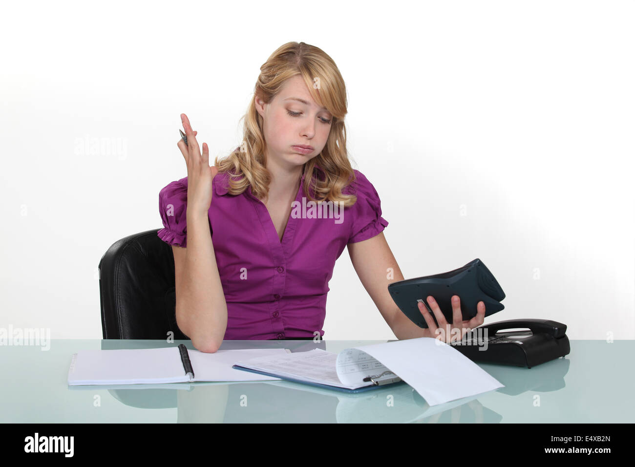 Exasperated woman with a calculator Stock Photo - Alamy