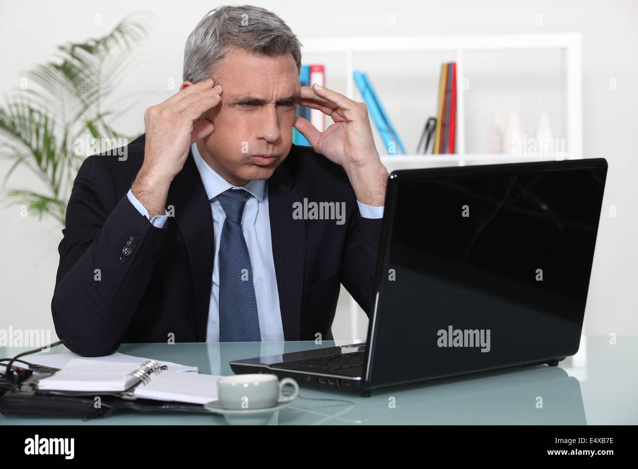 Man stressed with a laptop Stock Photo - Alamy