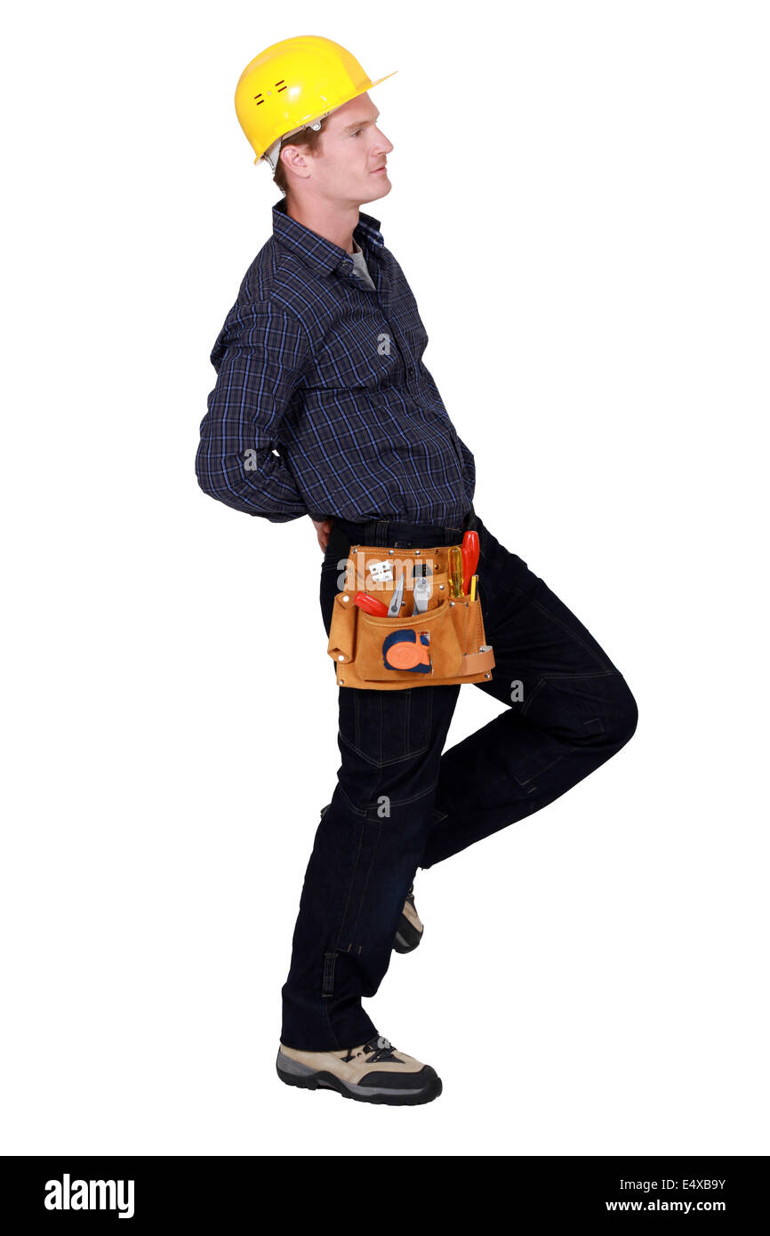 Tradesman hiding something behind his back Stock Photo - Alamy