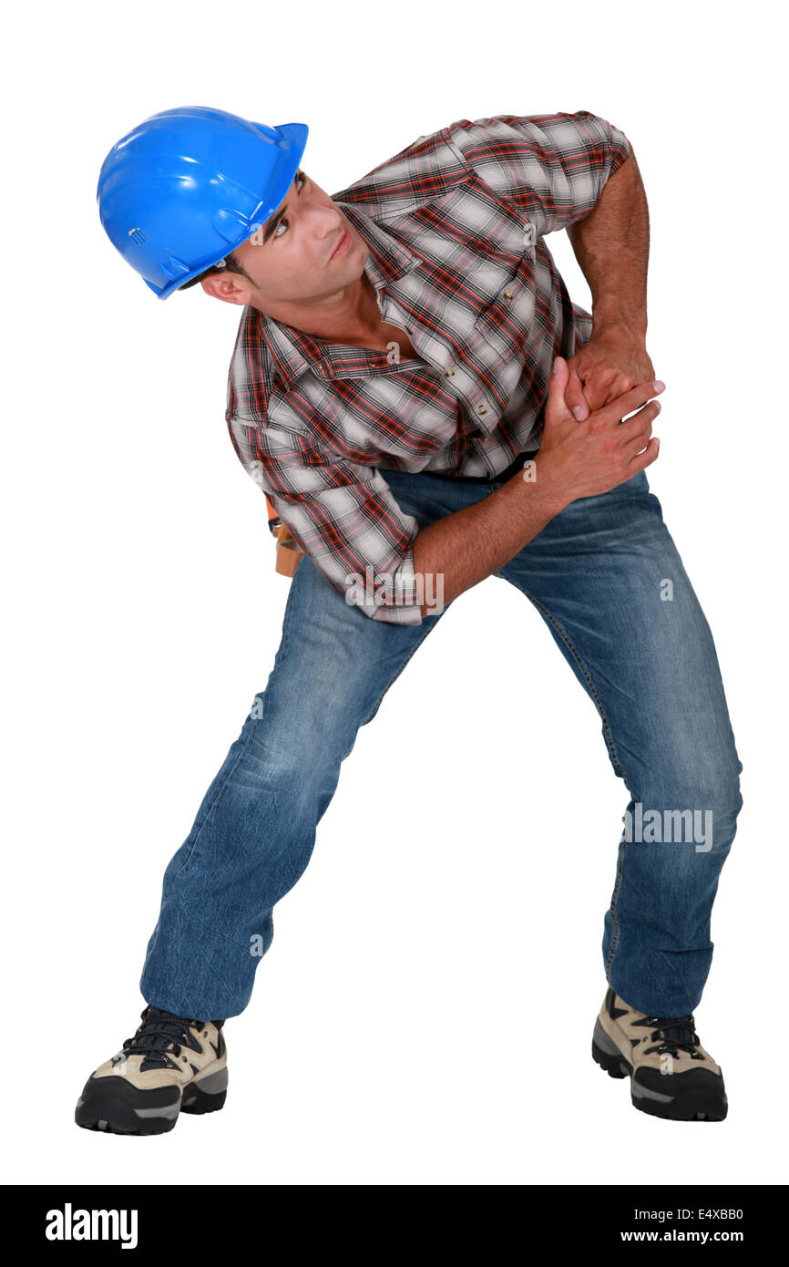 Builder with muscular pain Stock Photo - Alamy