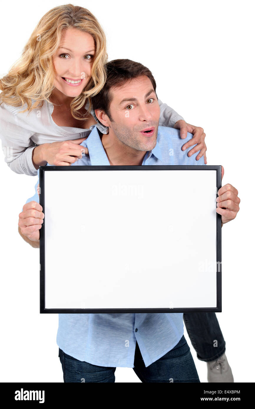 Couple holding blank message board Stock Photo - Alamy