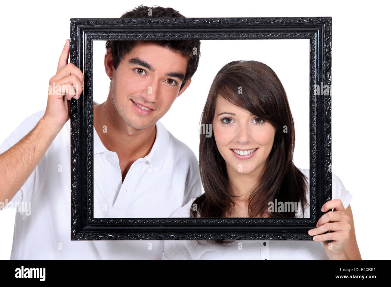 Couple holding empty picture frame Stock Photo - Alamy
