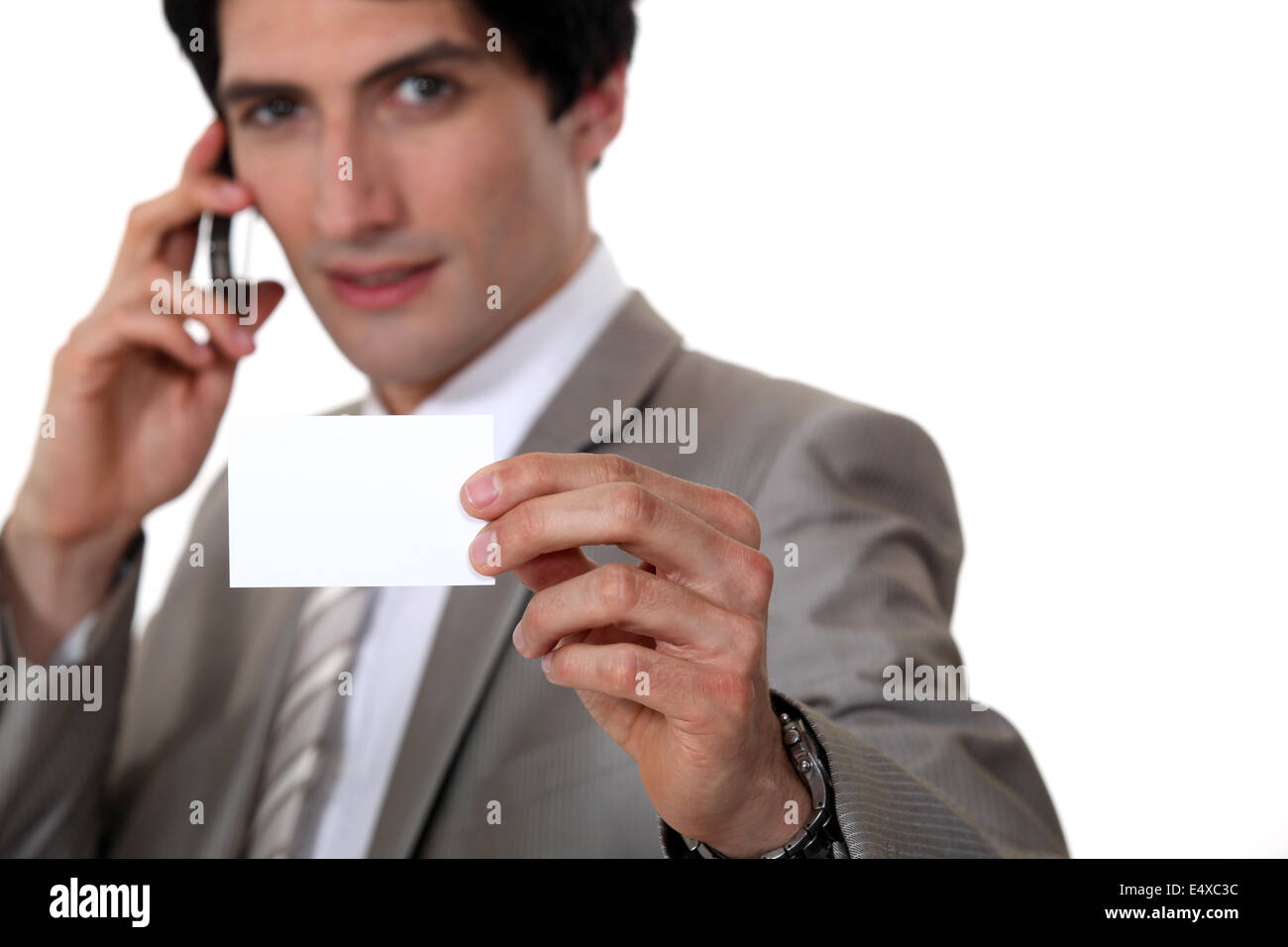 Man holding up his business card Stock Photo - Alamy