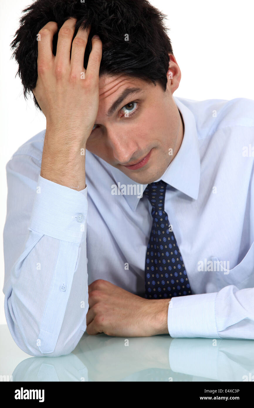 Businessman holding his head Stock Photo - Alamy