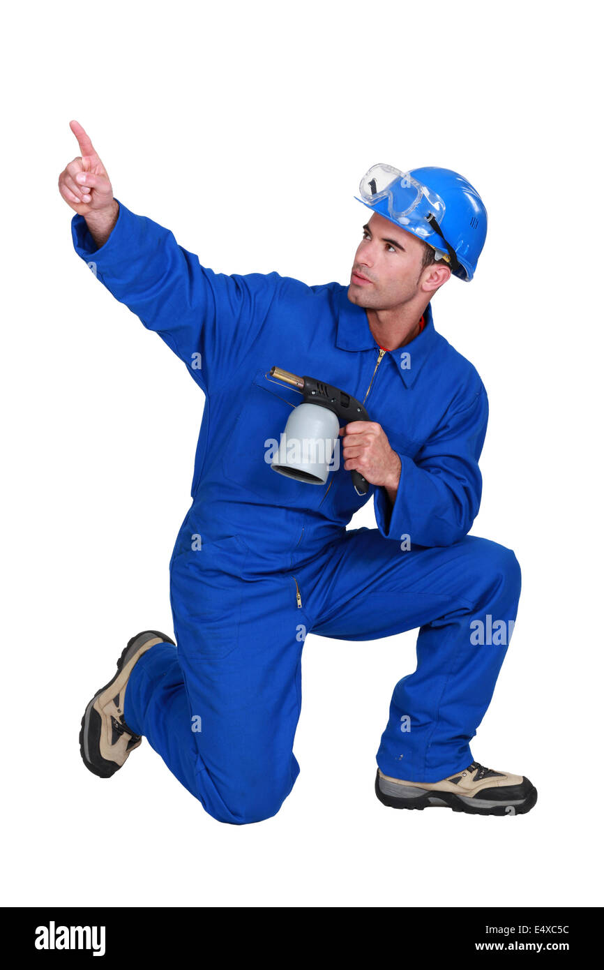 Man with blowtorch pointing Stock Photo - Alamy