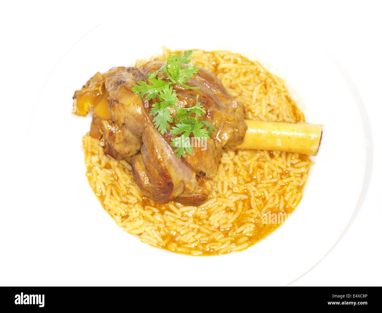 Lamb shank in juicy yellow rice Stock Photo - Alamy