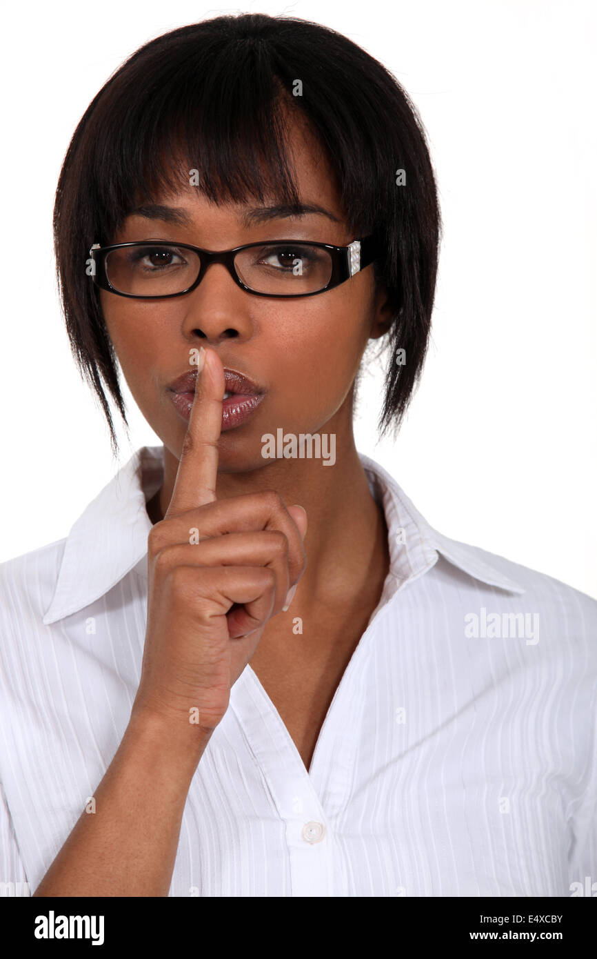 woman doing a silence sign Stock Photo - Alamy
