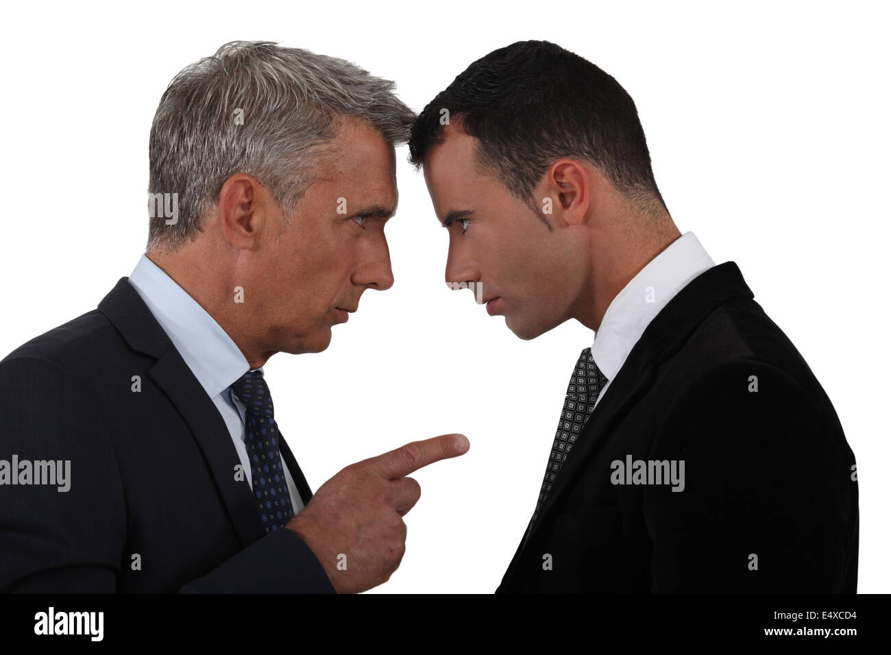 Younger and older businessmen head to head Stock Photo - Alamy