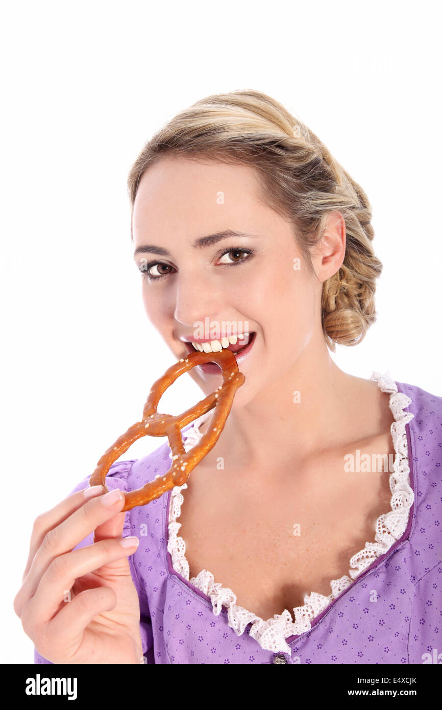 Beautiful woman biting a pretzel Stock Photo - Alamy