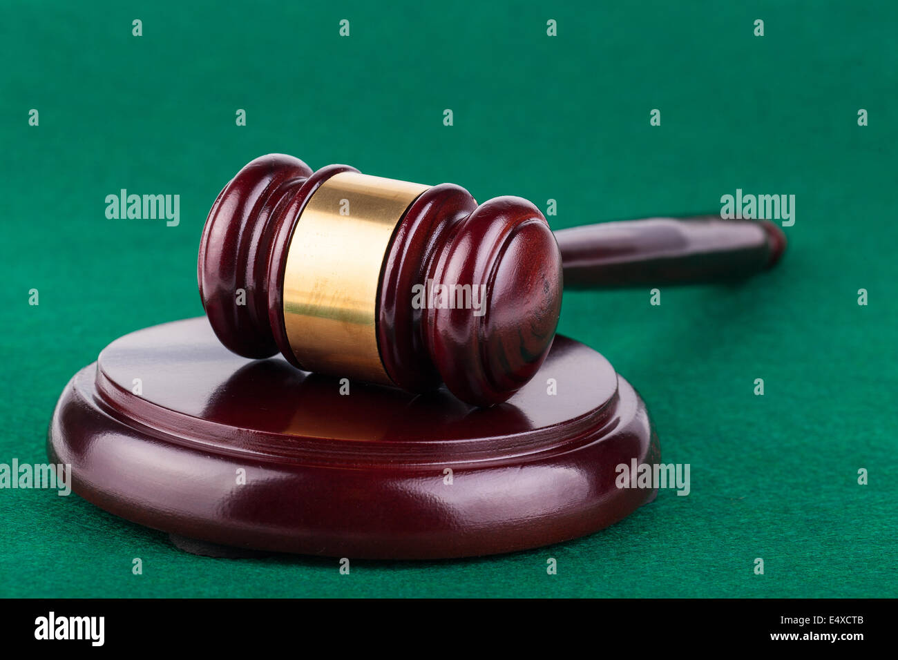 Gavel on green background Stock Photo - Alamy