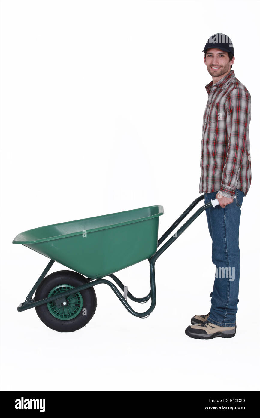 Construction worker pushing a wheelbarrow hi-res stock photography and ...