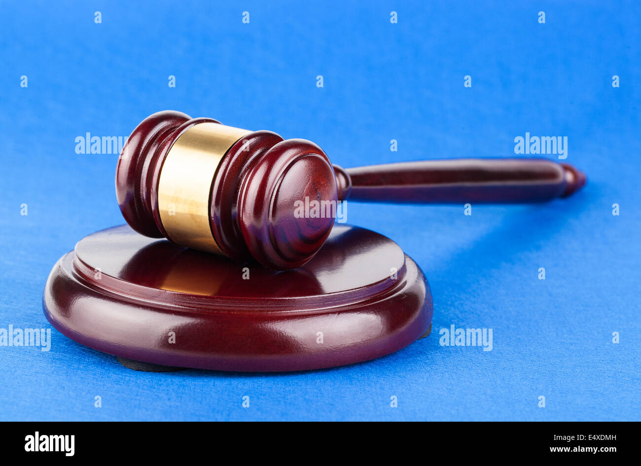 Wooden judges gavel on blue table Stock Photo - Alamy