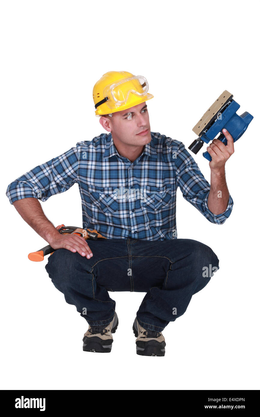 Man holding an electric sander Stock Photo - Alamy
