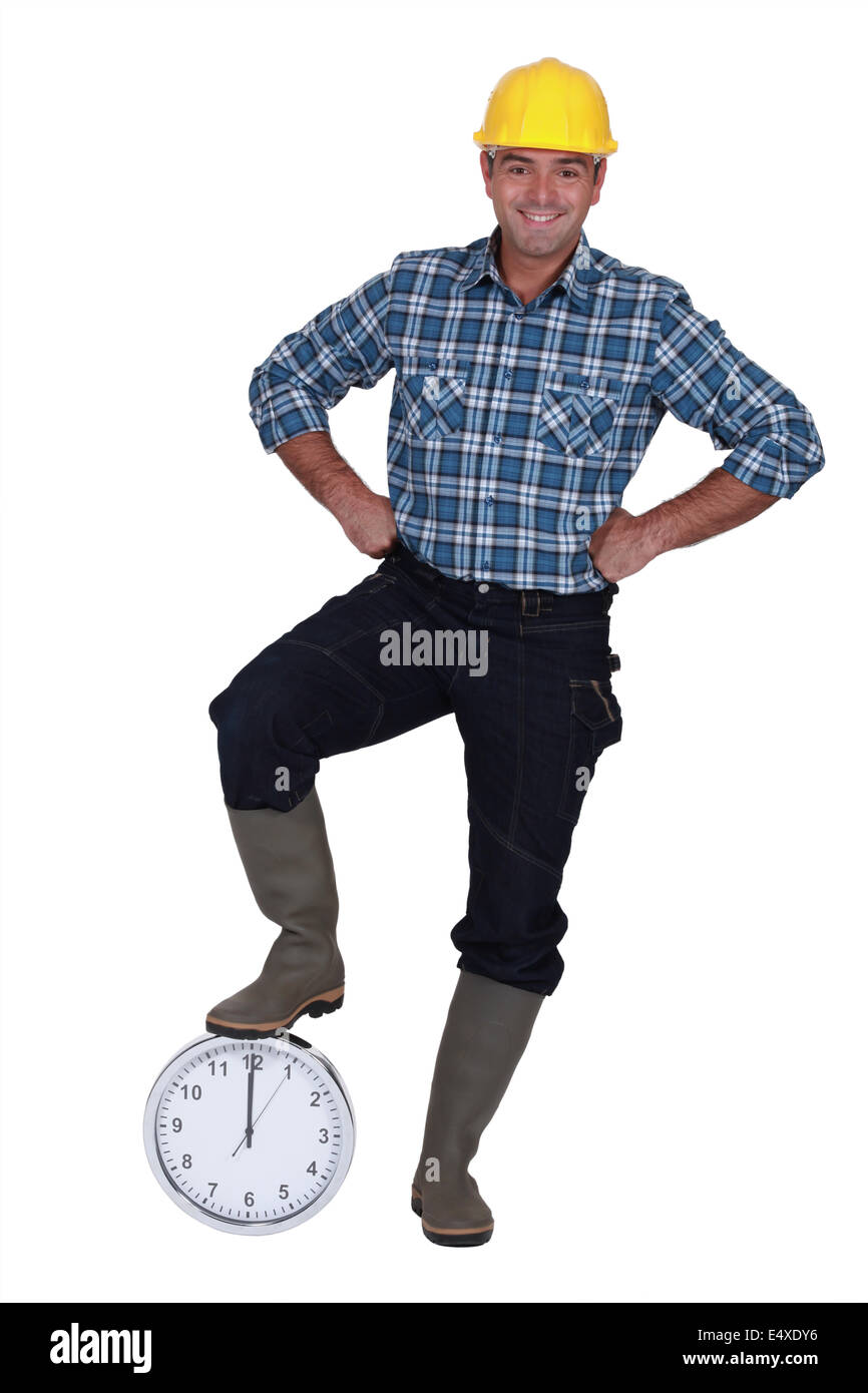 Builder with a clock Stock Photo - Alamy