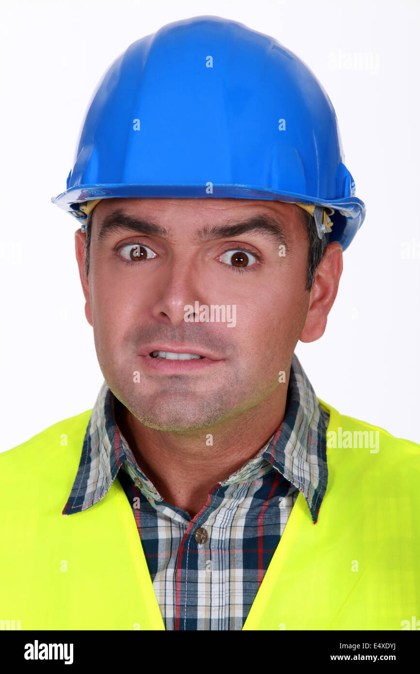 Portrait of horrified builder Stock Photo - Alamy