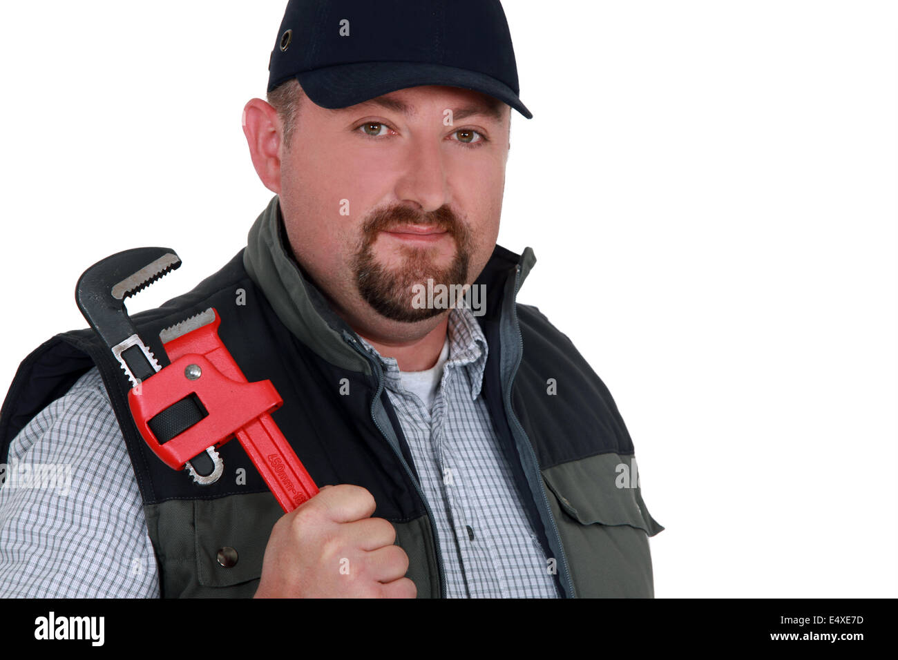 Construction worker holding a pipe wrench Stock Photo - Alamy