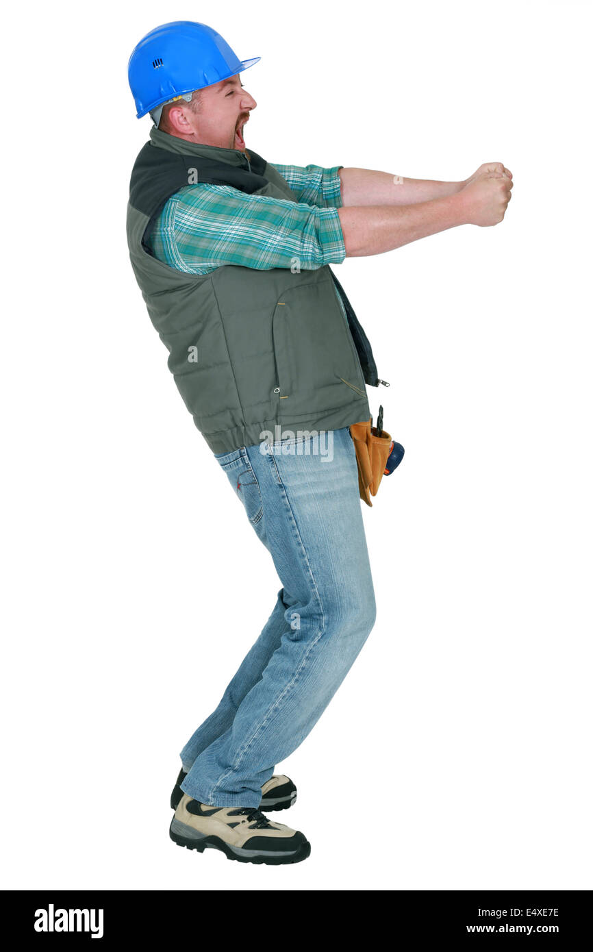 Construction worker pulling something Stock Photo - Alamy