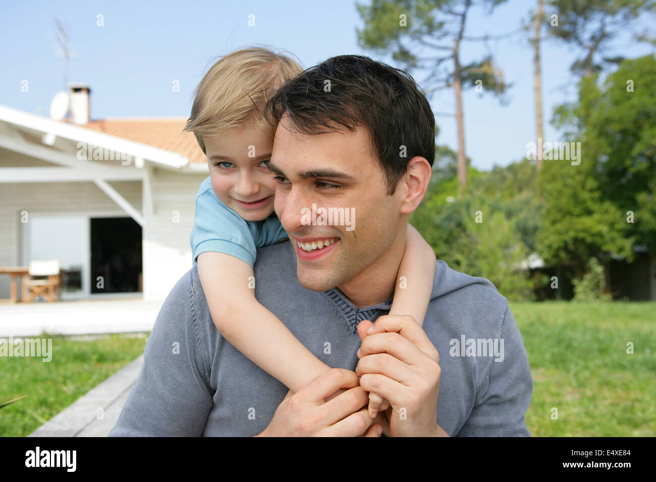 Piggy-back in the garden Stock Photo - Alamy