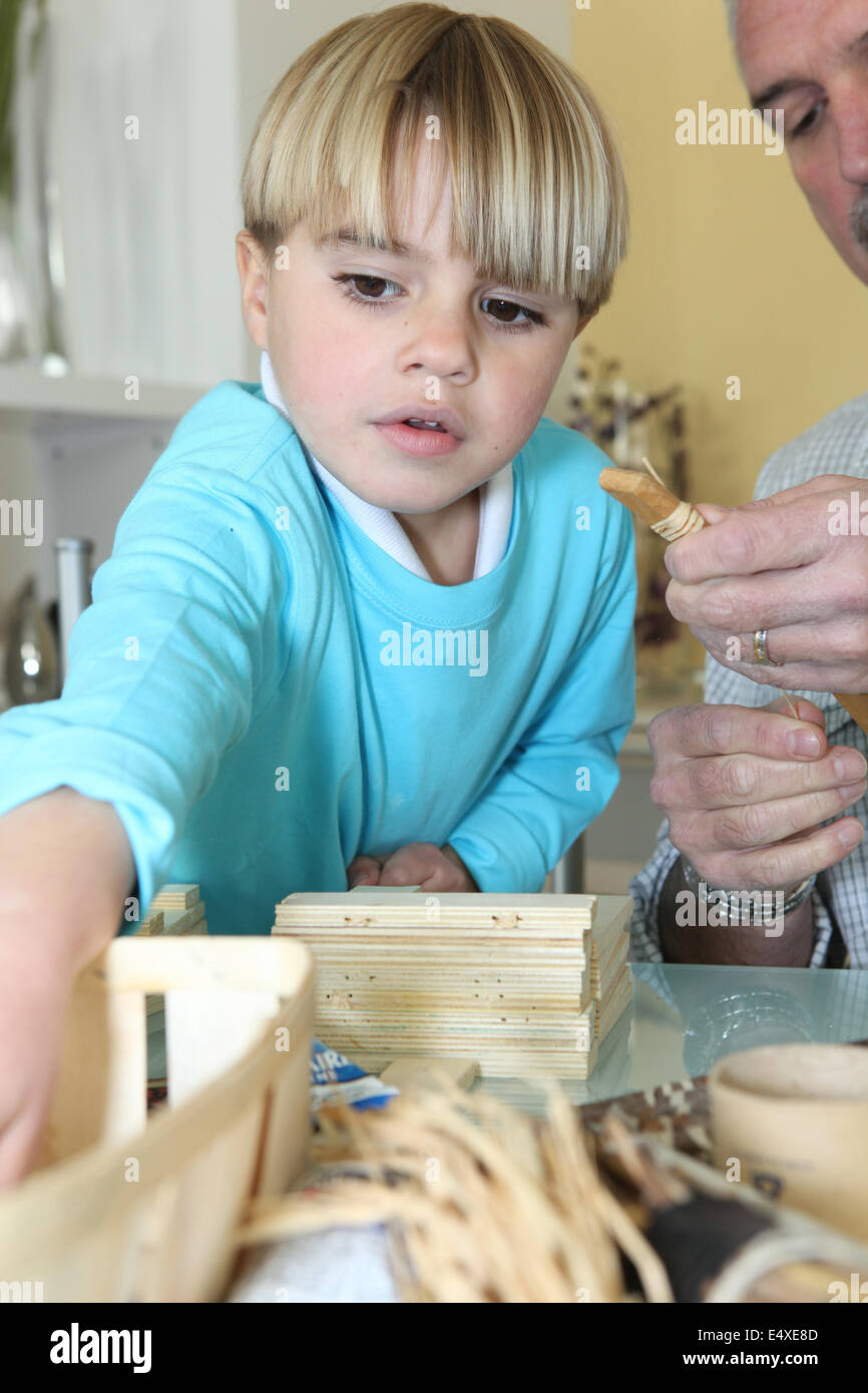 grandfather giving grandson biscuit Stock Photo - Alamy