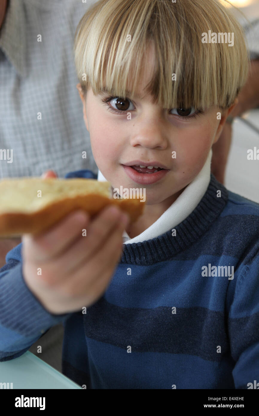 Boy with slice of bread Stock Photo - Alamy
