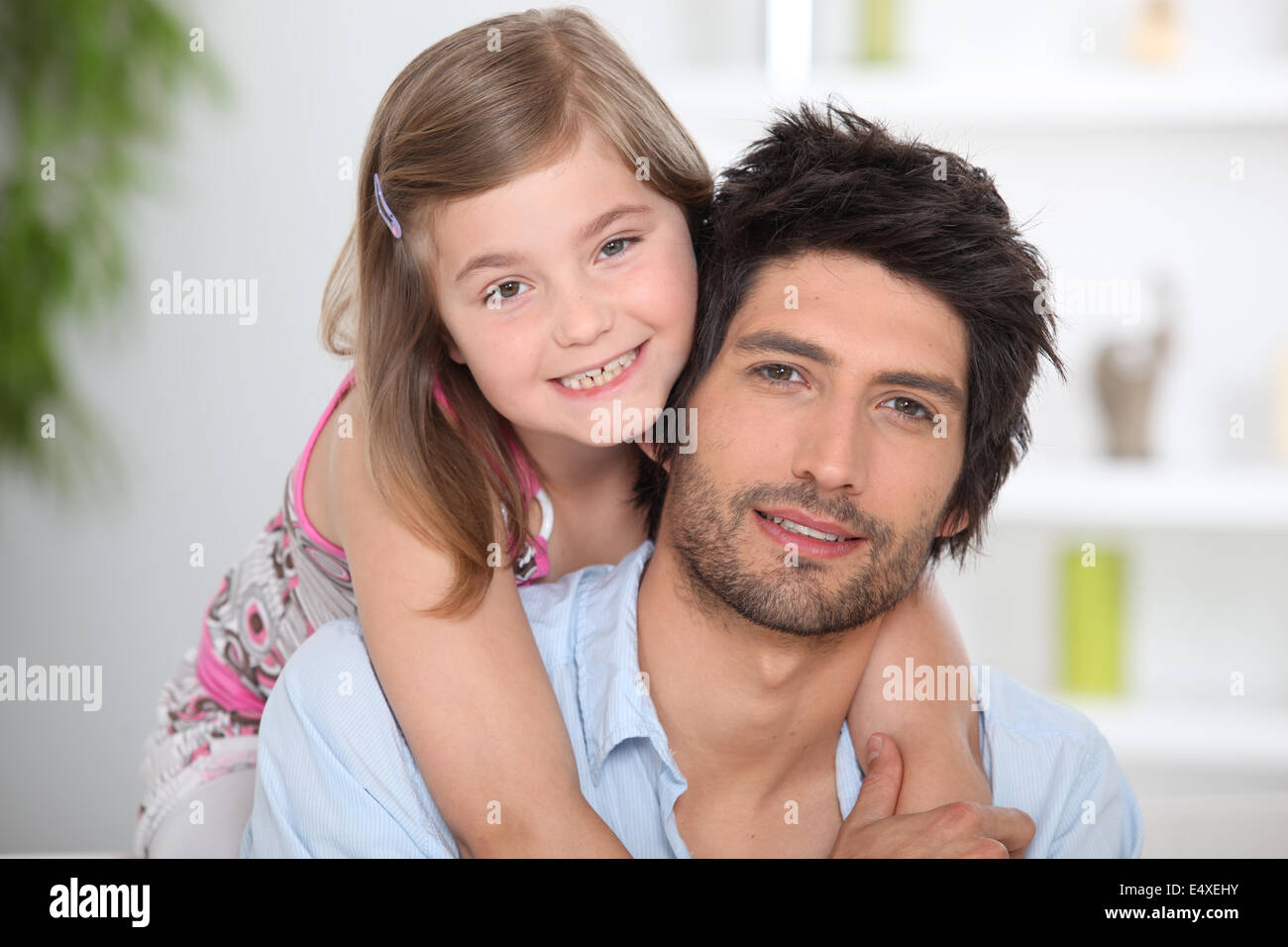 Girl hugging her dad Stock Photo - Alamy