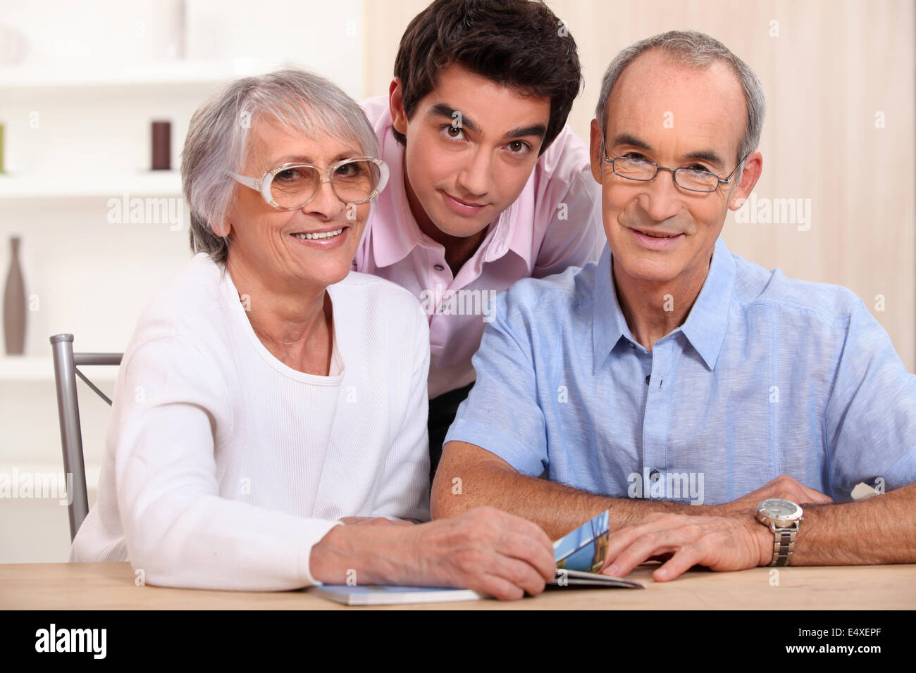 Grandson posing with his grandparents Stock Photo - Alamy