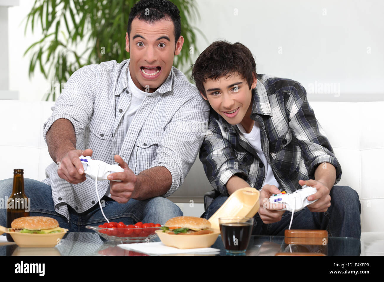 man and boy playing to video games Stock Photo - Alamy