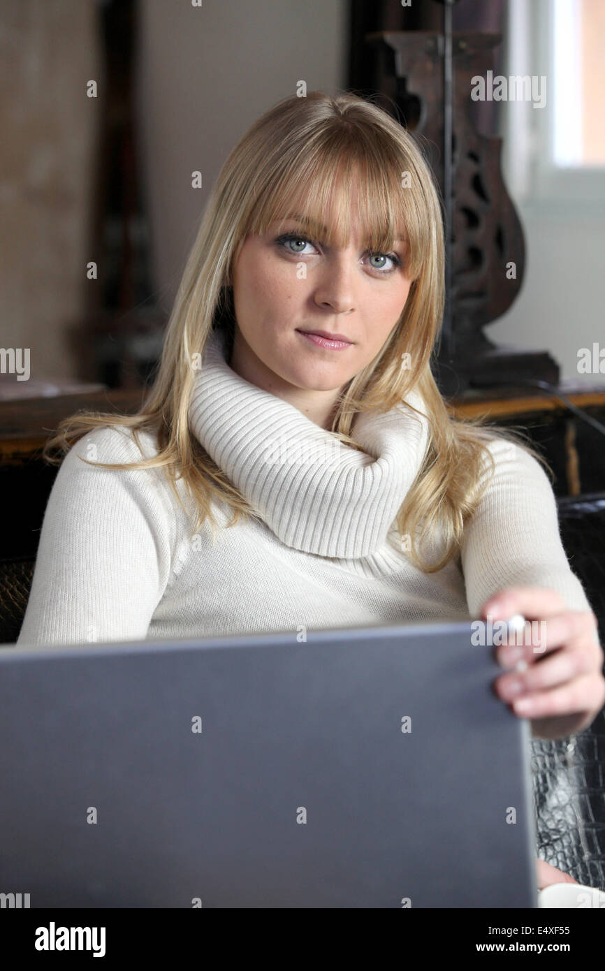 Young woman using a laptop Stock Photo - Alamy