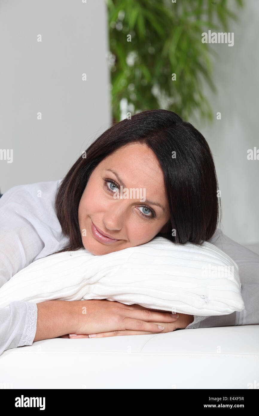 Woman hugging a pillow Stock Photo - Alamy