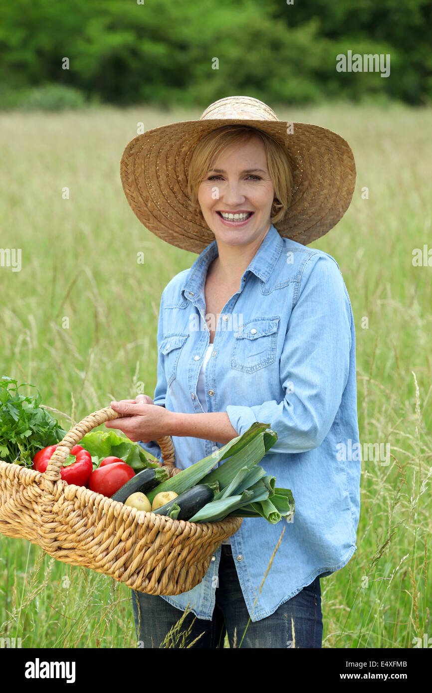 Woman with vegetable basket Stock Photo - Alamy