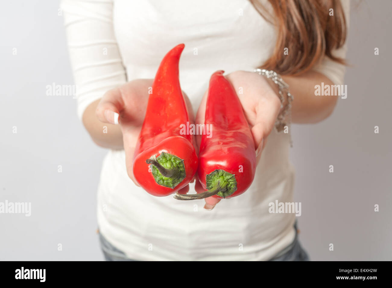 red peppers in hands Stock Photo - Alamy