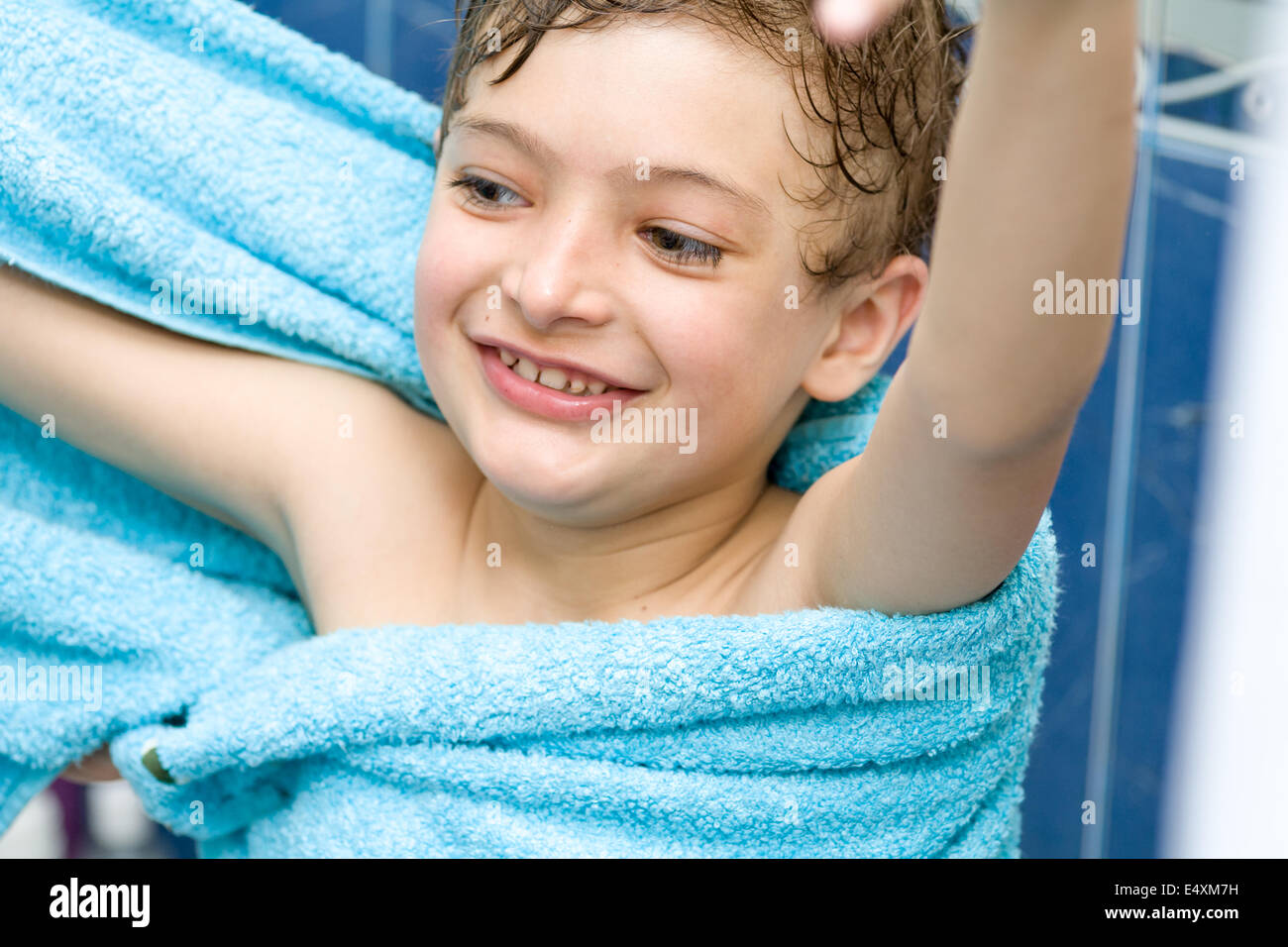 boy after bath in blue towel play Stock Photo - Alamy