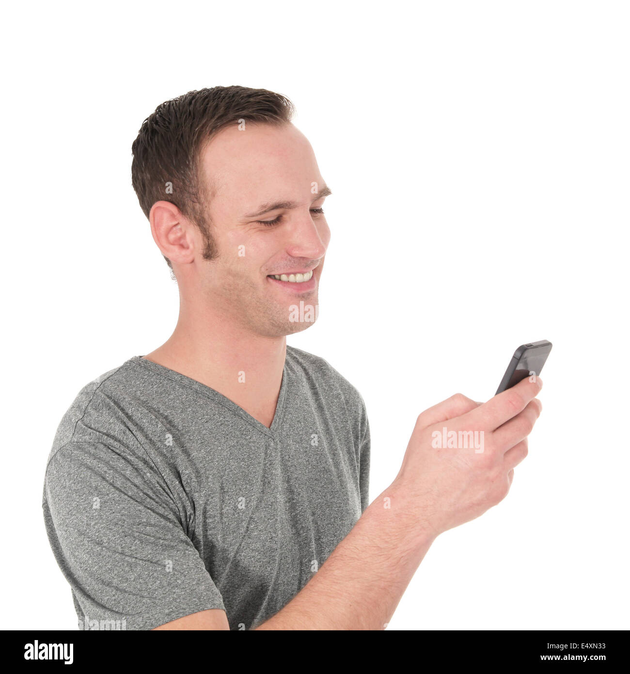 Happy young man reading a text message Stock Photo - Alamy
