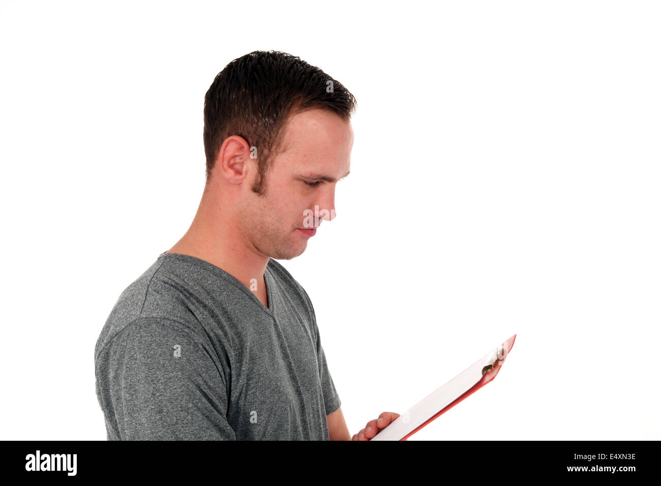 Man reading notes on a clipboard Stock Photo - Alamy