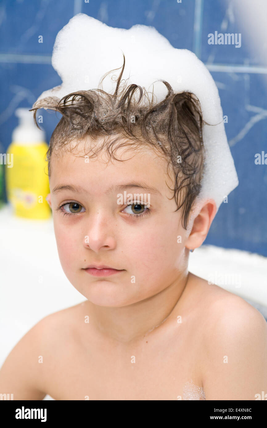 Smiling little boy covered with soap bubbles Stock Photo - Alamy