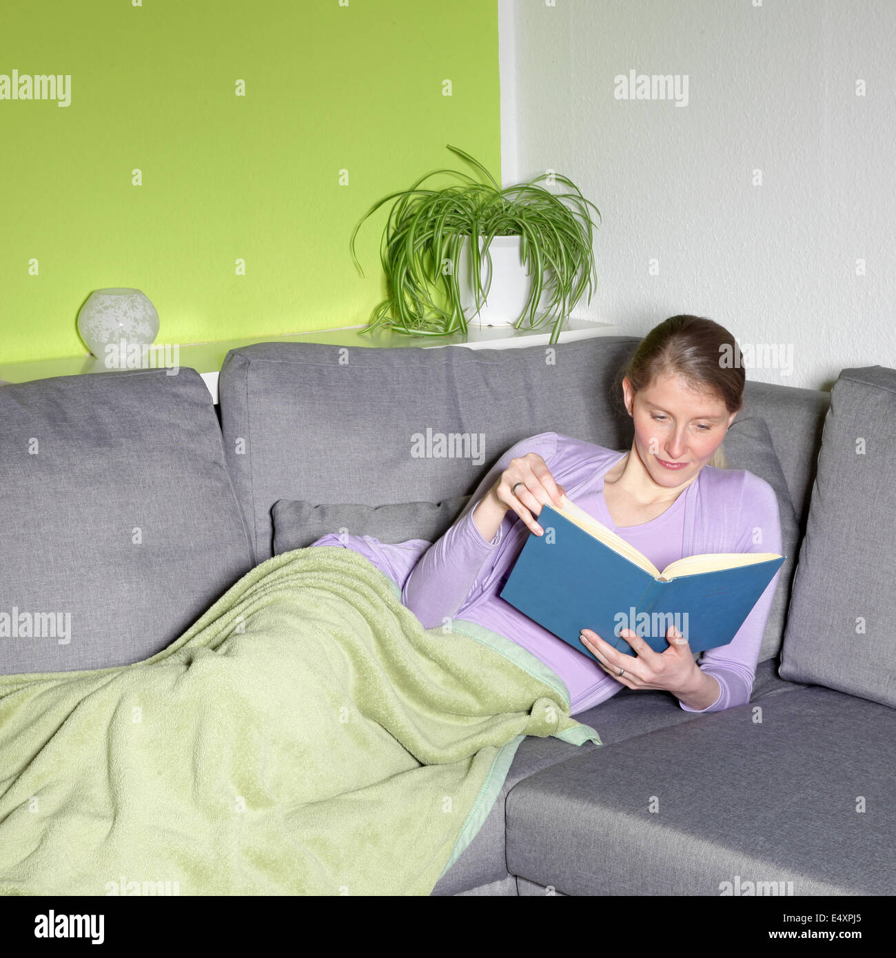 Mature woman reclining on sofa hi-res stock photography and images - Alamy