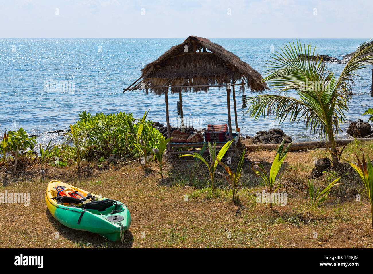 Plastic kayak on the shore next to the hut Stock Photo - Alamy