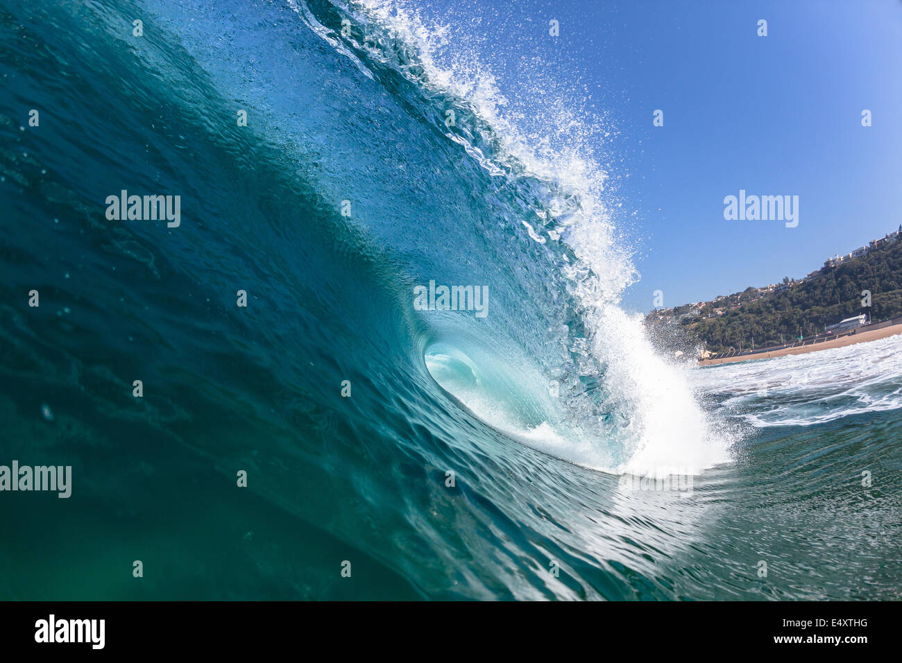 Ocean blue hollow wave crashing breaking power and energy along beach ...