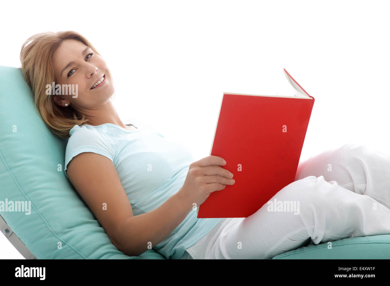 Woman relaxing reading a book Stock Photo - Alamy