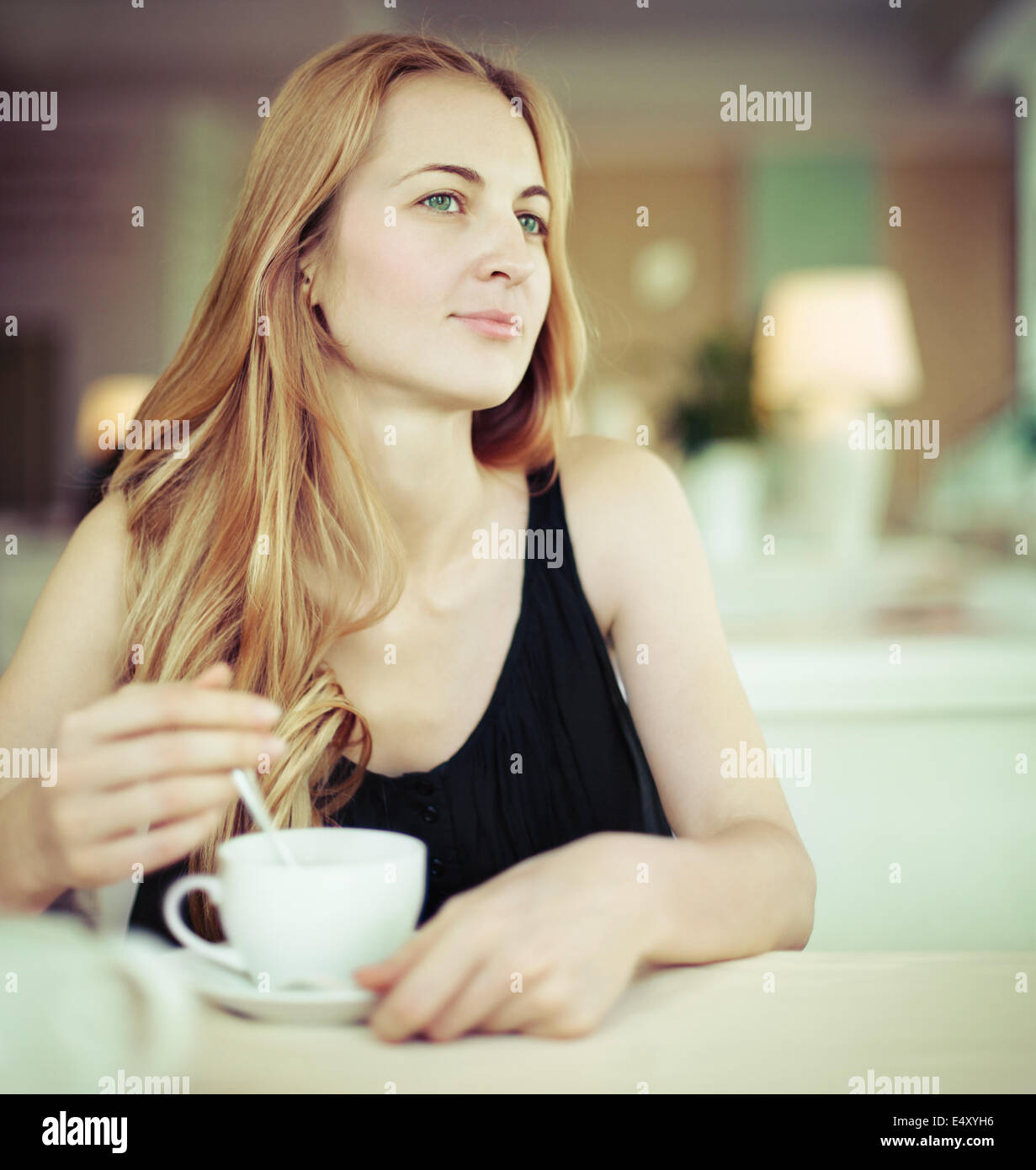 Smiling woman drinking coffee Stock Photo - Alamy