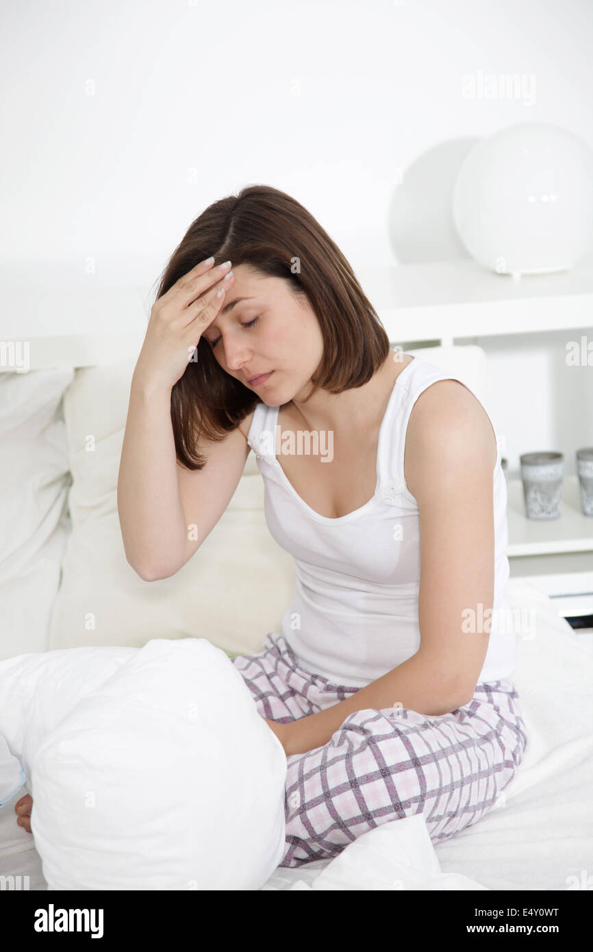 Tired woman with a headache Stock Photo - Alamy