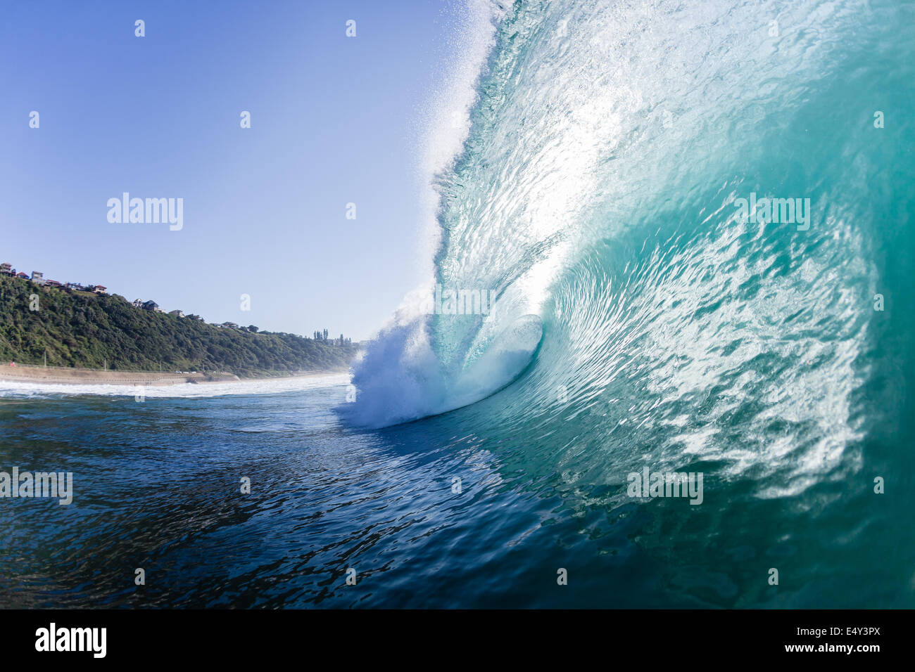 Ocean blue hollow wave crashing breaking power and energy along beach ...