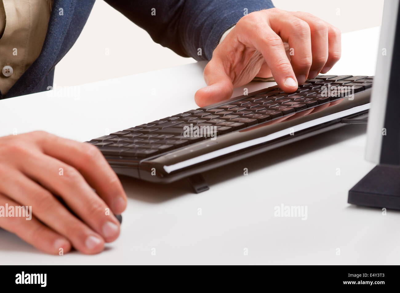 Man Working at a Computer Keyboard Stock Photo - Alamy