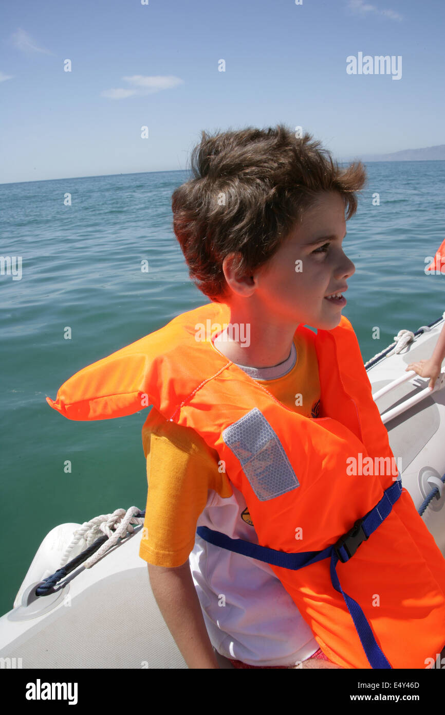Spain. Catalonia. Young boy with life jacket on a boat Stock Photo - Alamy
