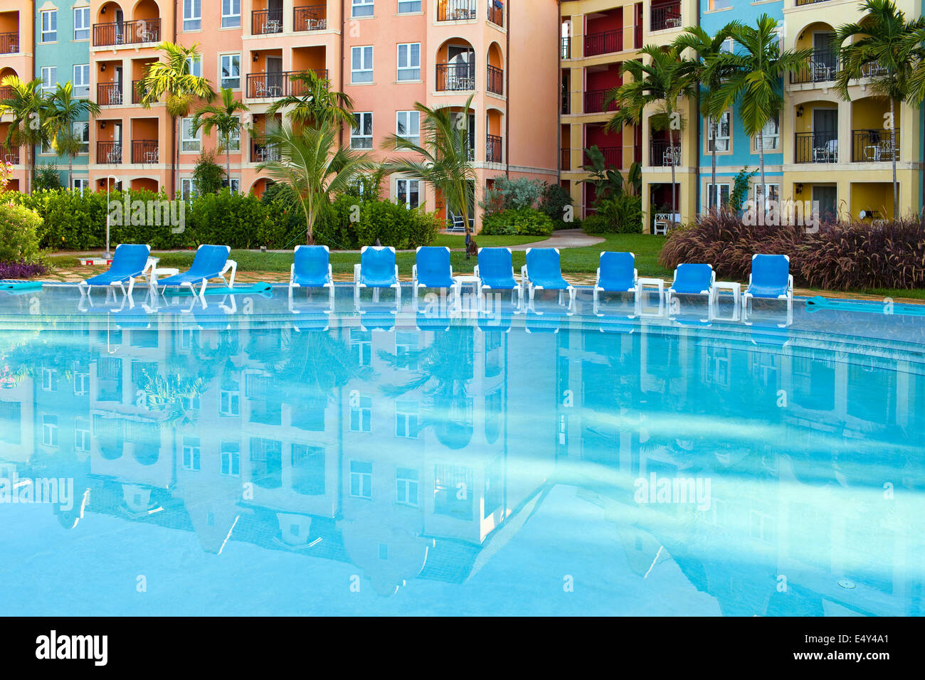 Empty chaise lounges near pool Stock Photo - Alamy