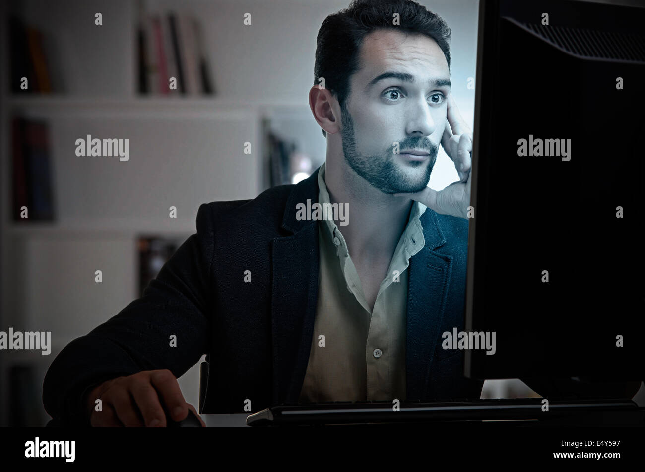 Suprised Man Looking At A Computer Monitor Stock Photo - Alamy